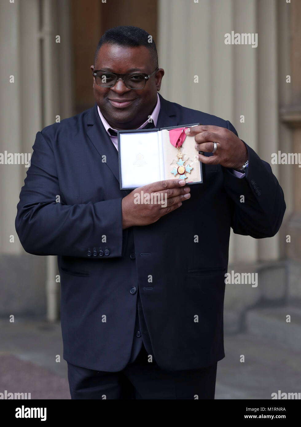 Isaac Julien after he was awarded a CBE by the Prince of Wales during ...