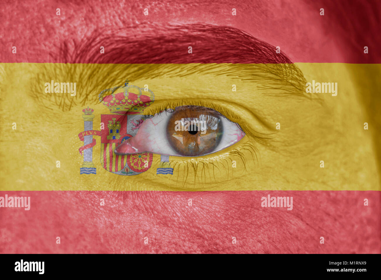 Human face and eye painted with flag of Spain Stock Photo - Alamy