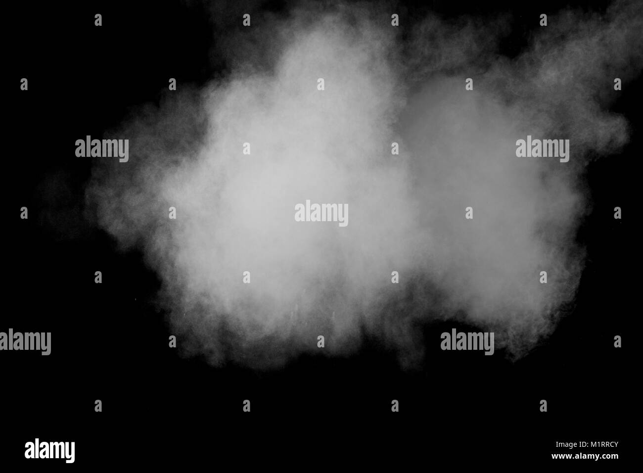 Launched white particle splash on black background Stock Photo - Alamy