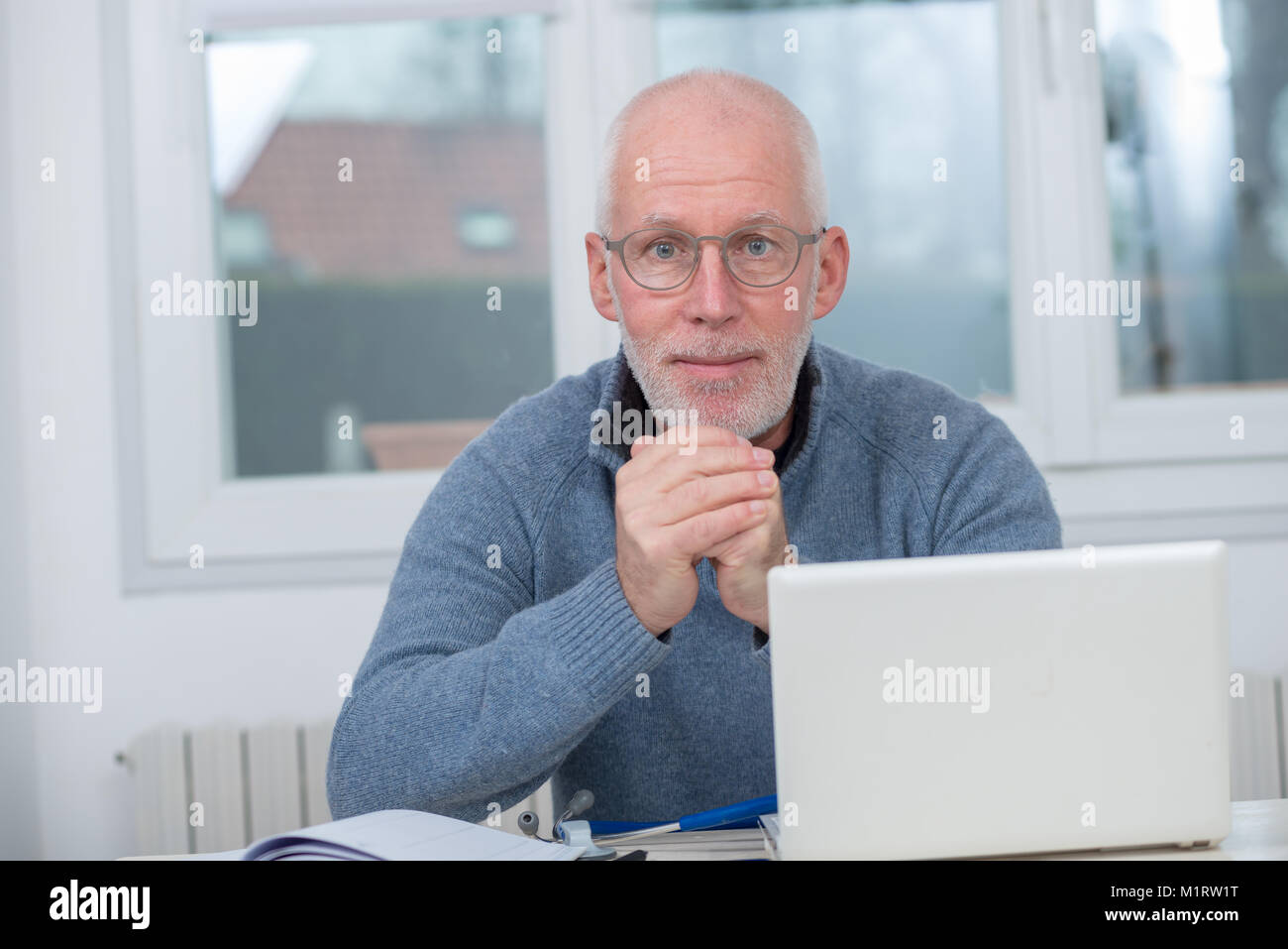 a middle-aged man using laptop in his office Stock Photo - Alamy