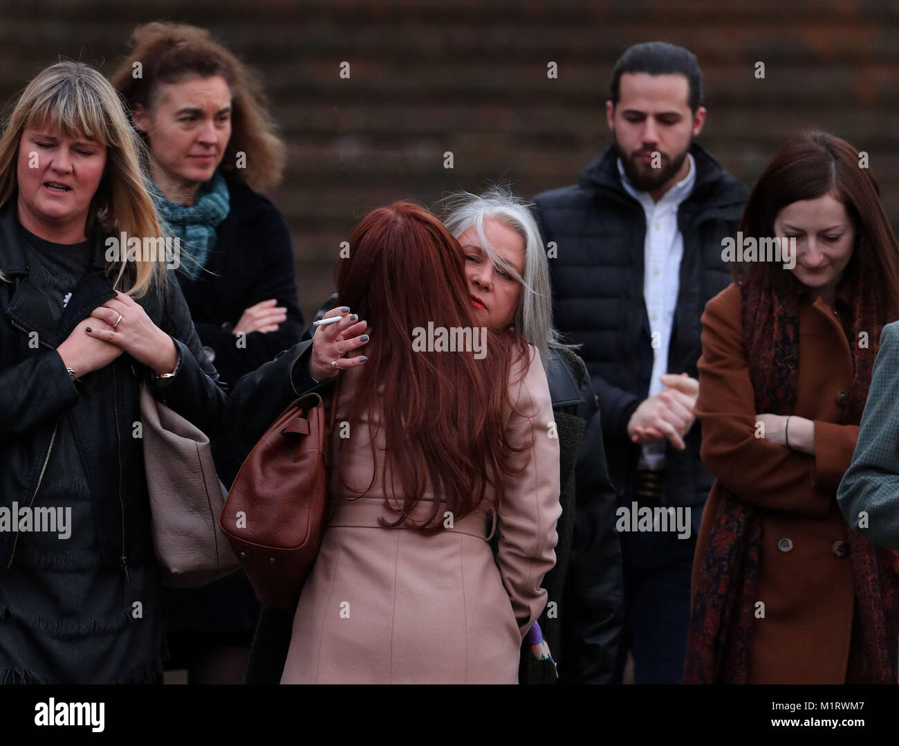 Joanne McLaren (centre), mother of Molly McLaren, is hugged as she ...