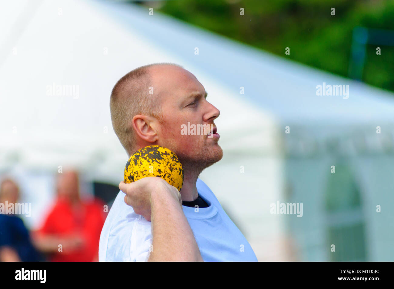 Muscular male prepares to throw in the shot put competition at the ...