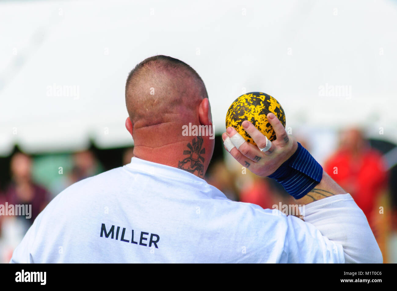 Muscular male prepares to throw in the shot put competition at the ...