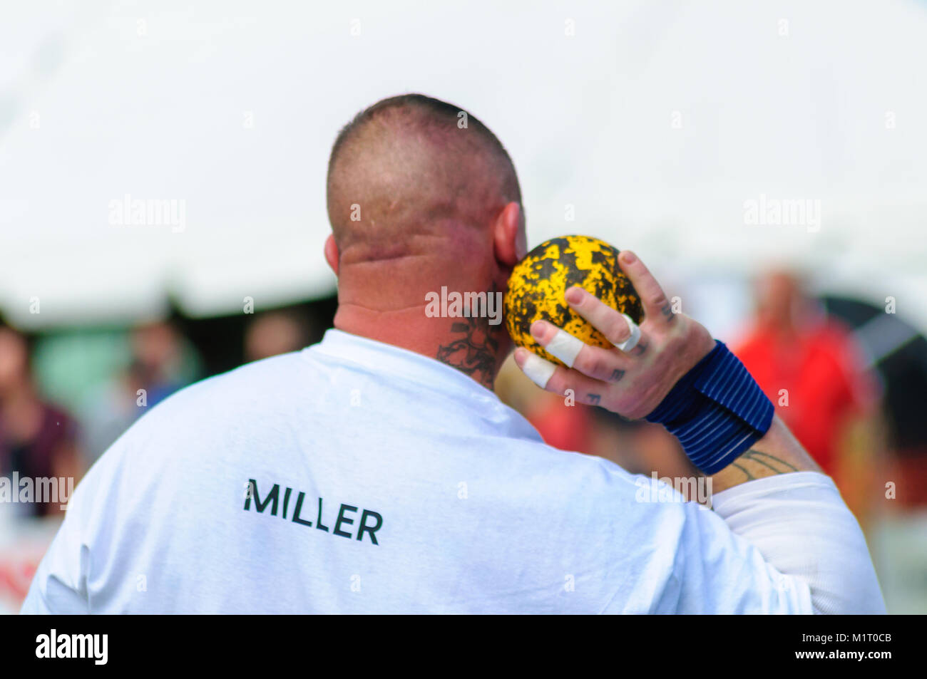 Muscular male prepares to throw in the shot put competition at the ...