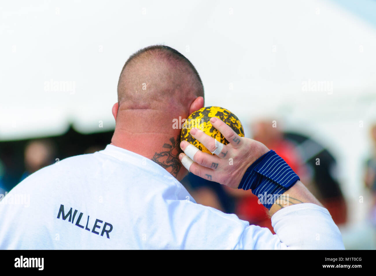 Muscular male prepares to throw in the shot put competition at the ...