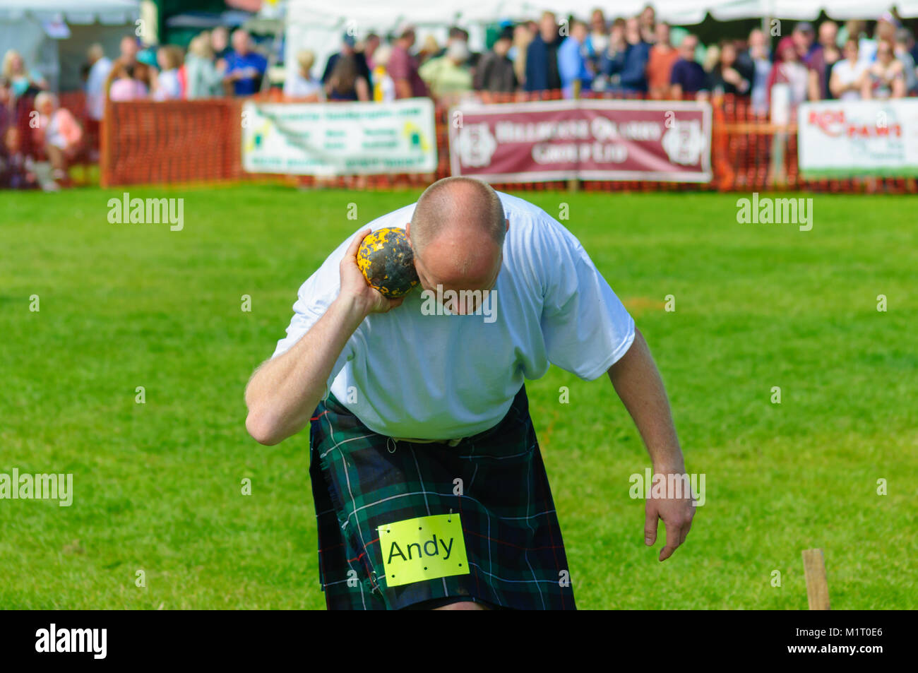 Muscular male prepares to throw in the shot put competition at the ...