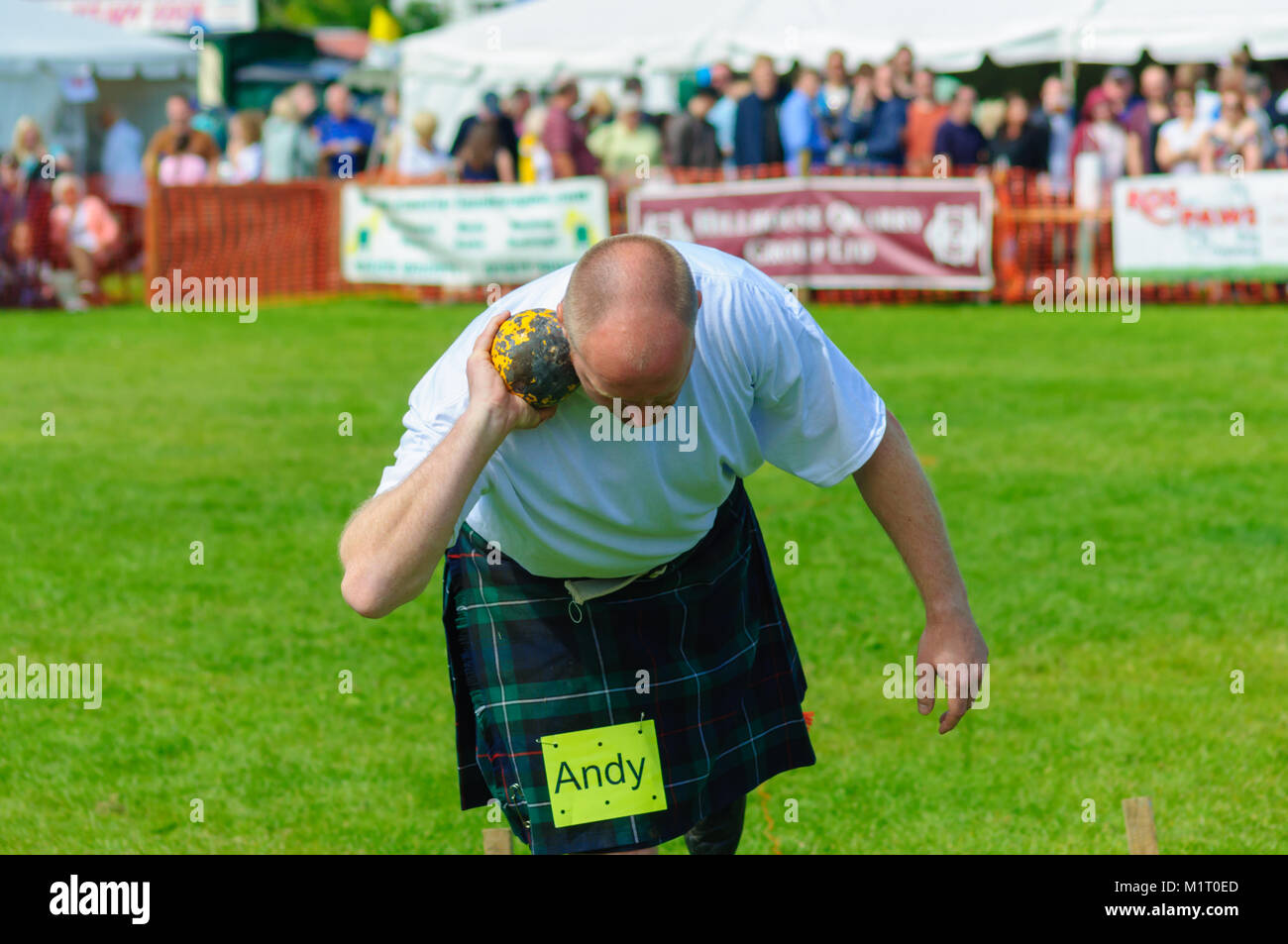Muscular male prepares to throw in the shot put competition at the ...
