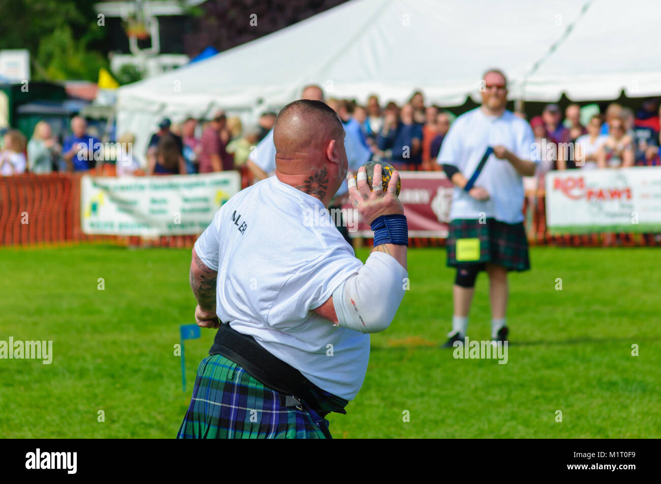 Muscular male prepares to throw in the shot put competition at the ...