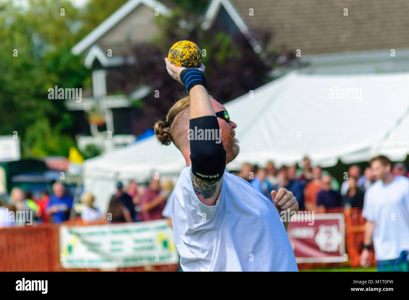 Muscular male prepares to throw in the shot put competition at the ...