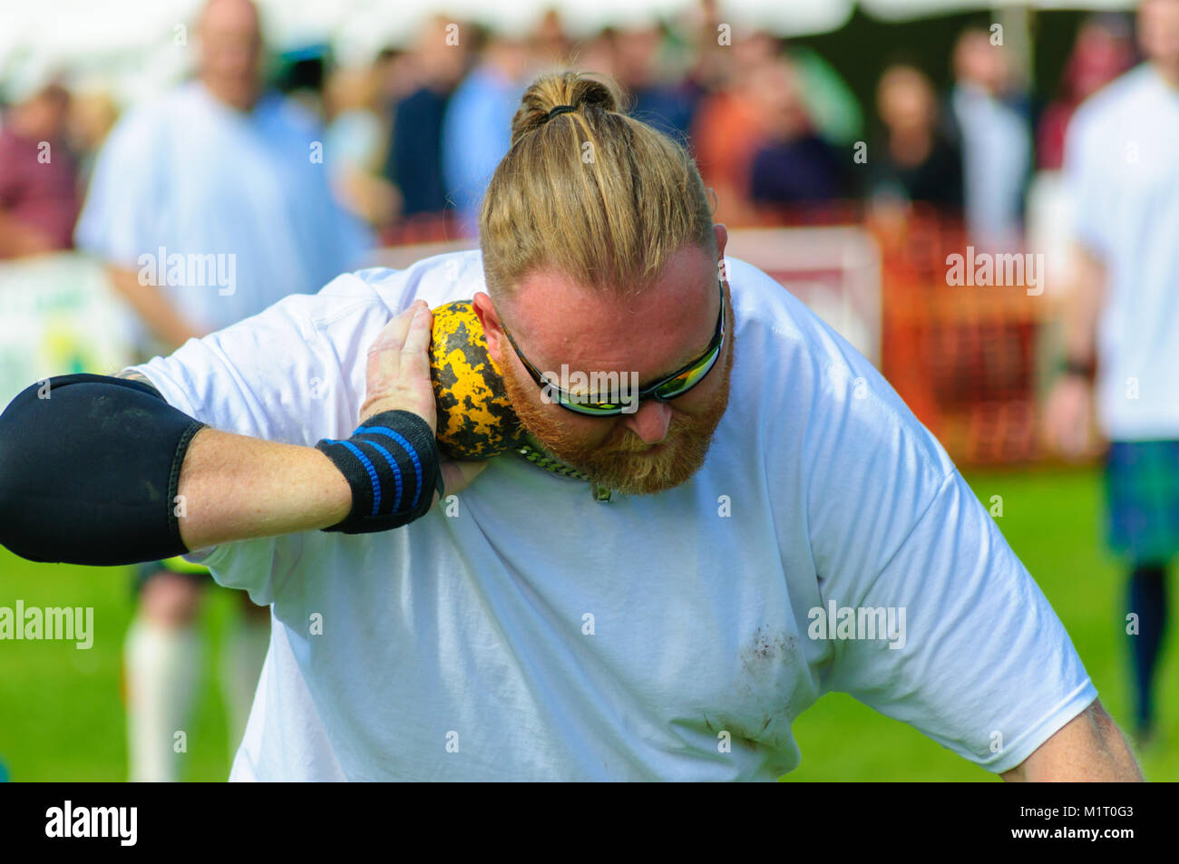 Muscular male prepares to throw in the shot put competition at the ...