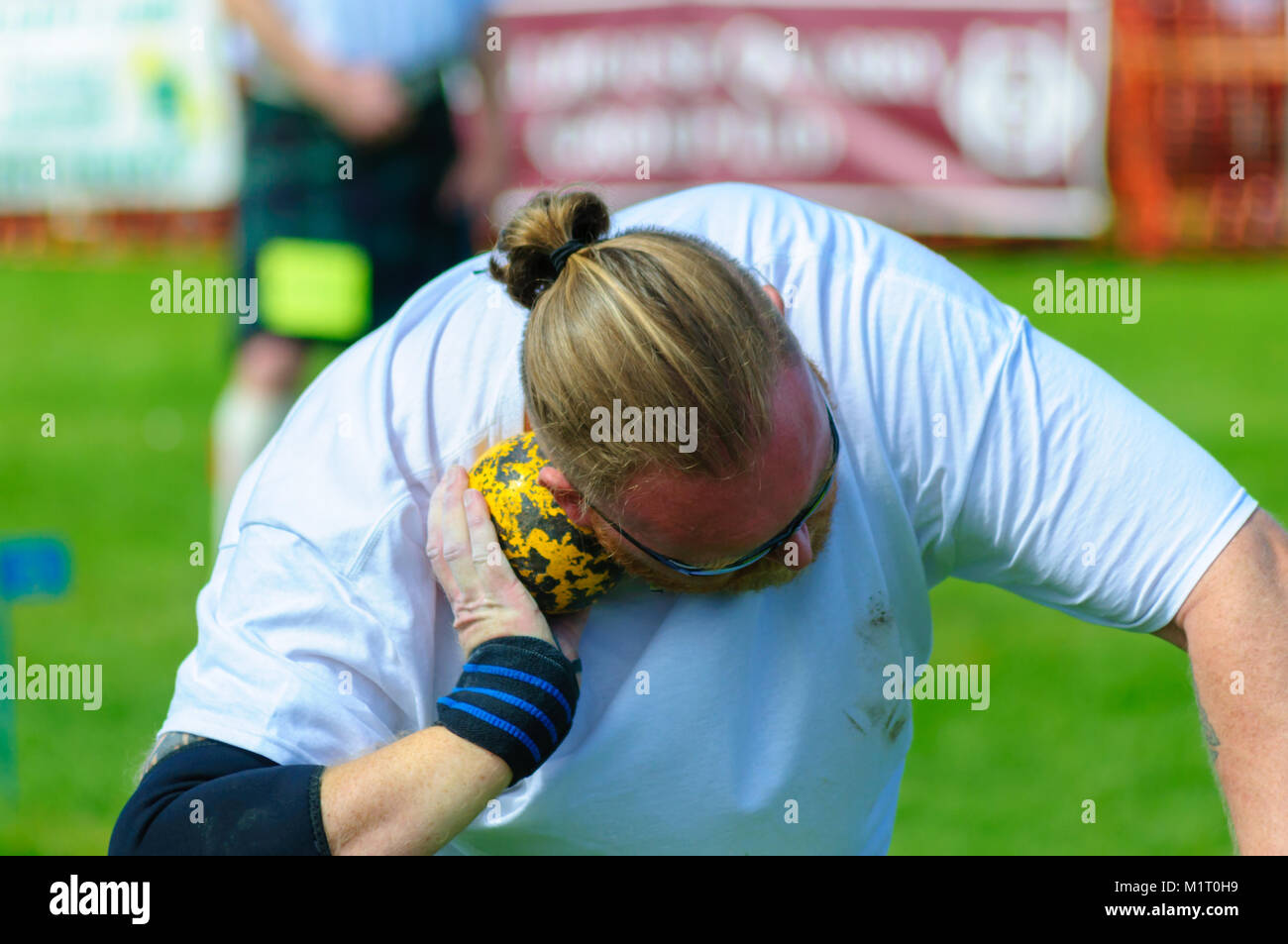 Muscular male prepares to throw in the shot put competition at the ...