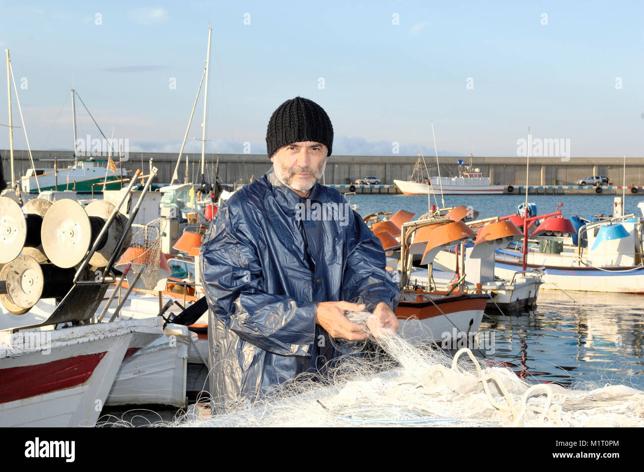 fisherman working in the fishing port Stock Photo - Alamy
