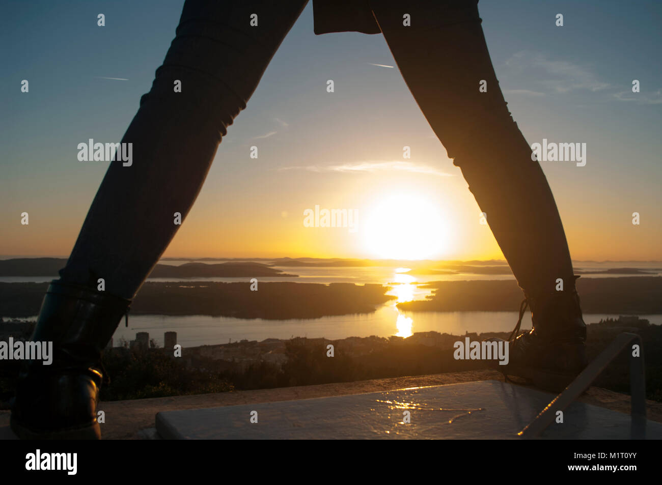 a view of the sunset between the legs Stock Photo - Alamy