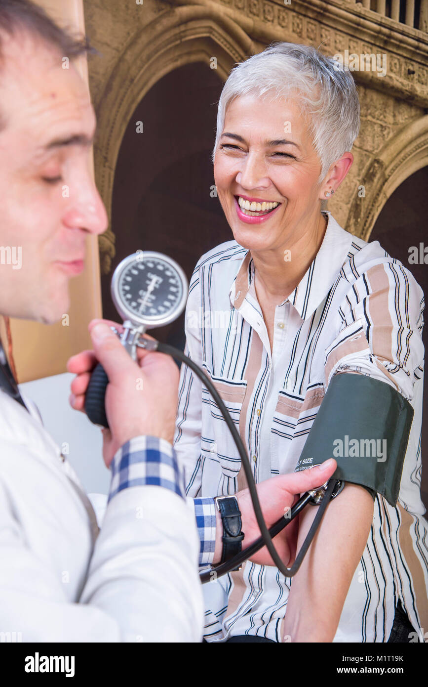 Senior woman checking her blood pressure at the clinic Stock Photo - Alamy