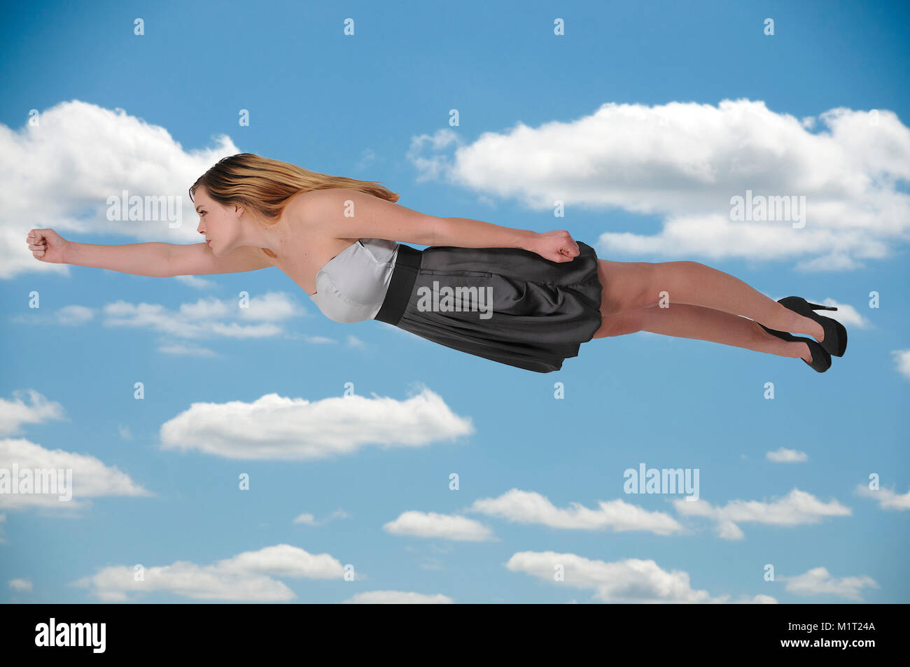 Beautiful young woman flying through the sky Stock Photo - Alamy