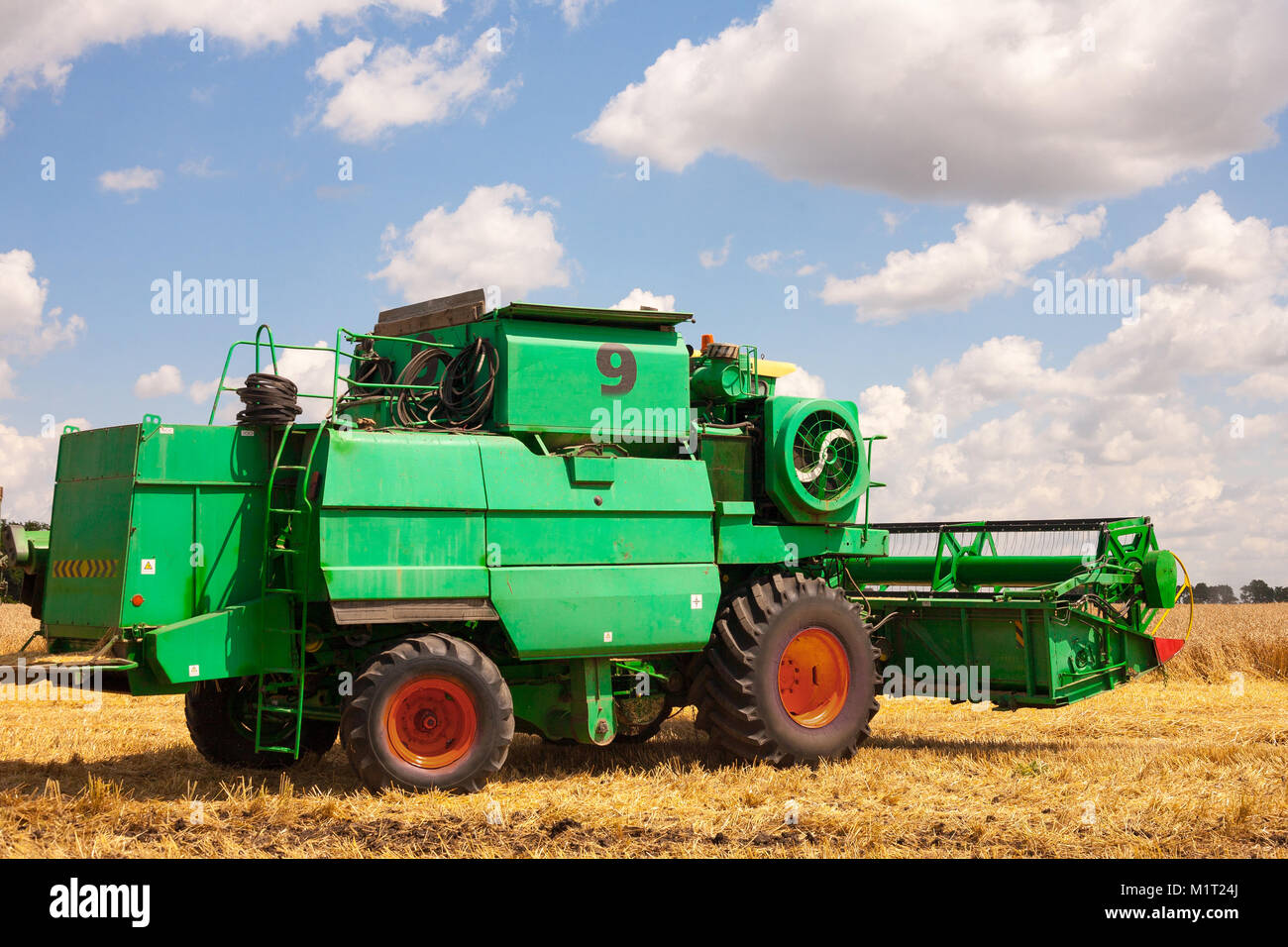 combine harvester working on a wheat field Stock Photo - Alamy
