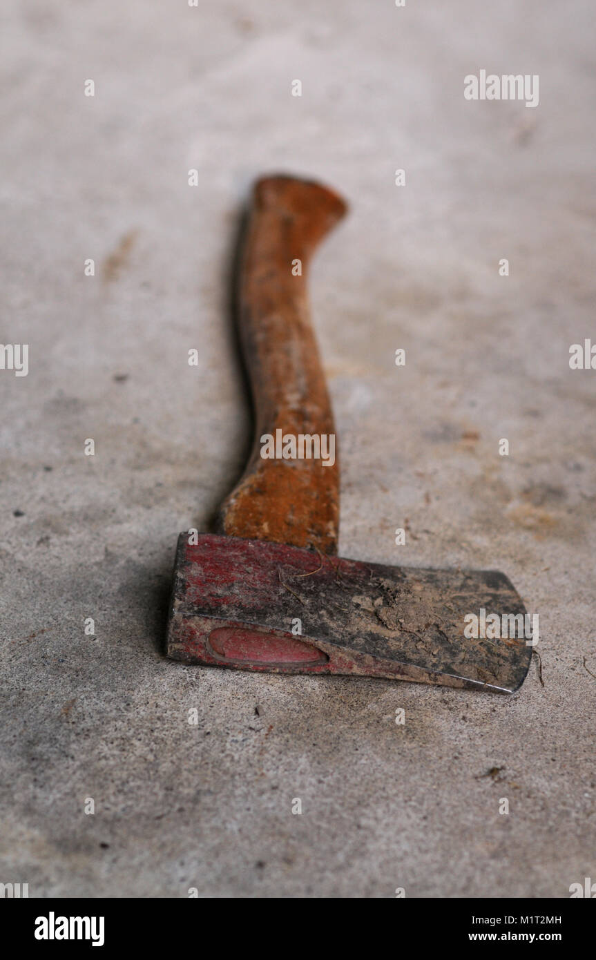 Dirty Hatchet on Concrete Stock Photo - Alamy