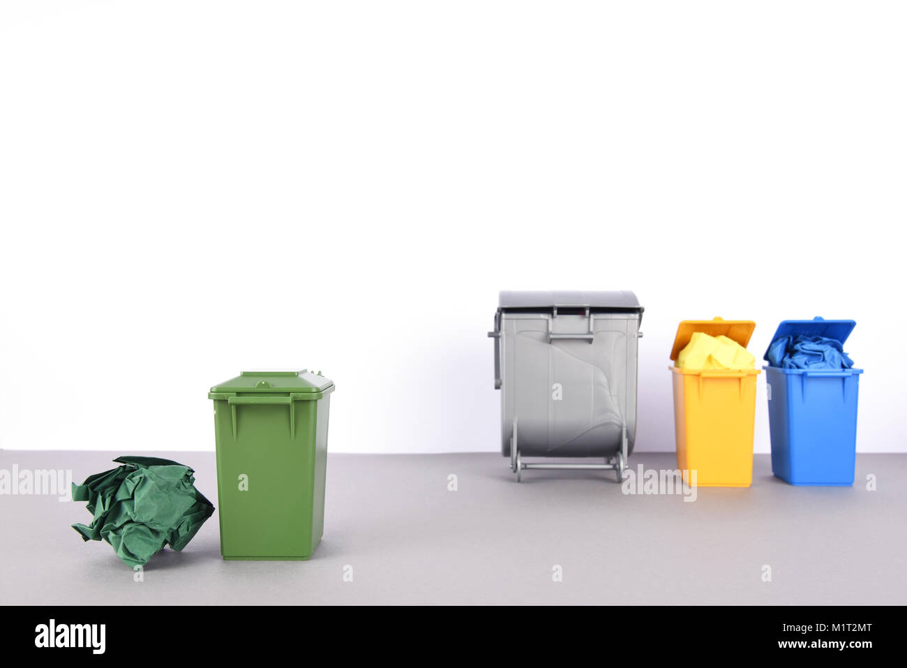 Colorful recycle bins on white and gray background. Recycling concept ...