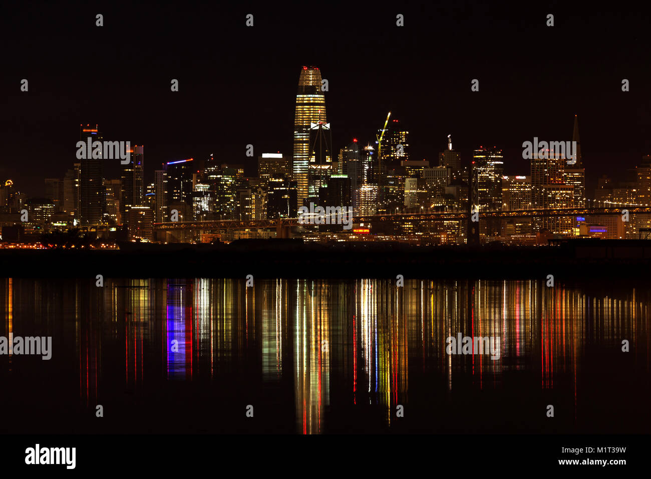 The San Francisco skyline is reflected in the waters of Alameda Lagoon ...