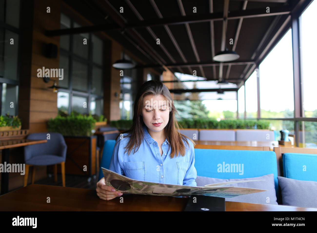 Pretty woman reading menu at restaurant with close up face Stock Photo ...