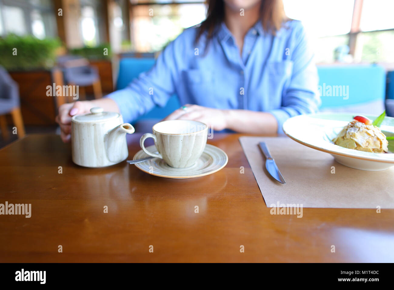 Charming restaurant customer pouring water into cup Stock Photo - Alamy