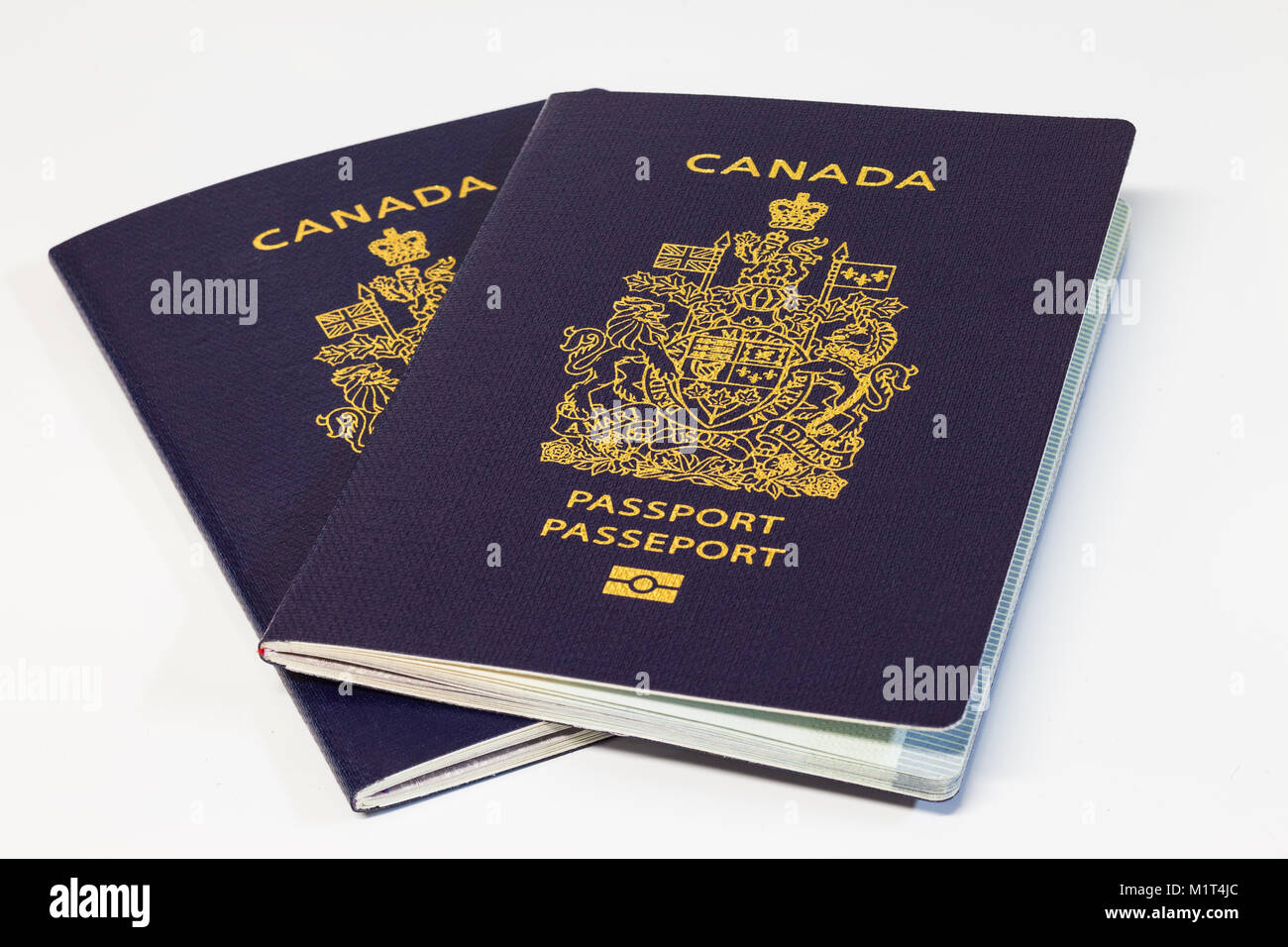 Two new Canadian passports on white background Stock Photo - Alamy