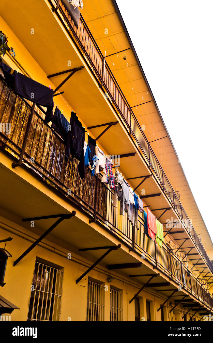 clothes drying from a balcony in a courtyard Stock Photo - Alamy