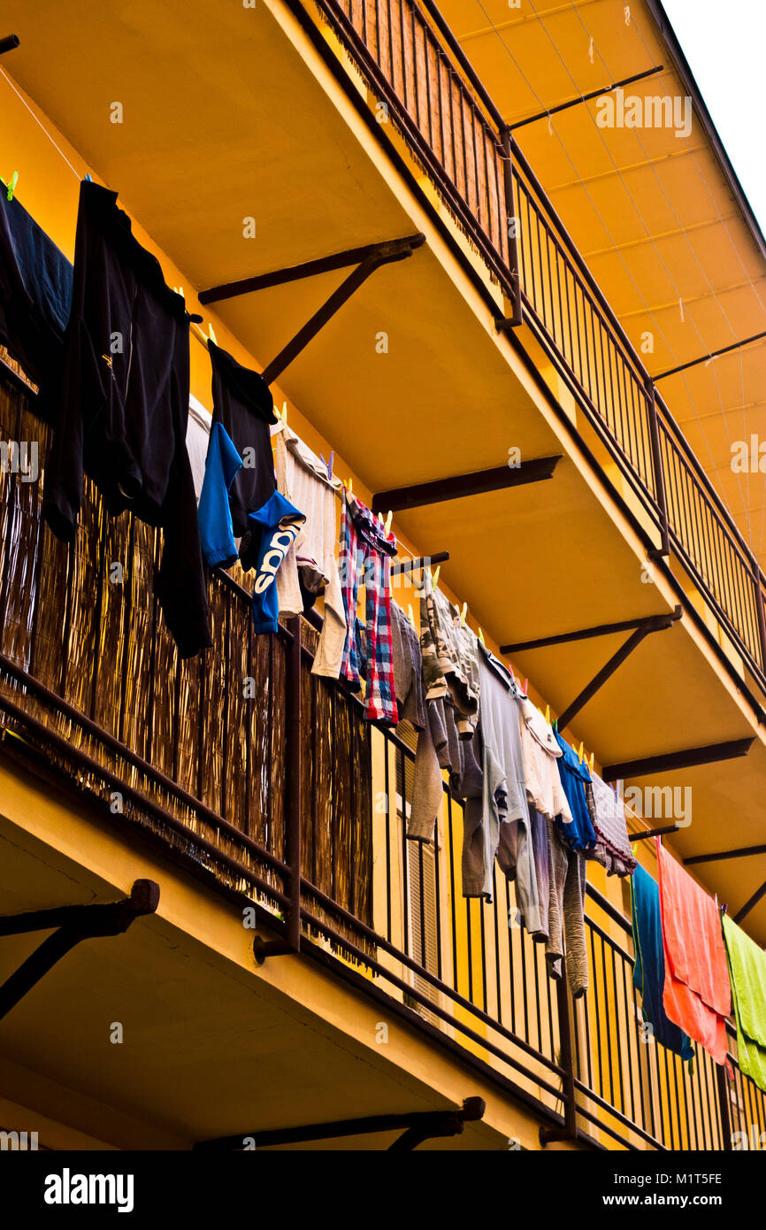 clothes drying from a balcony in a courtyard Stock Photo - Alamy