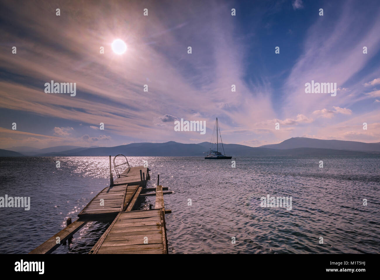 Sea view with sailboat and beautiful clouds at sunset Stock Photo - Alamy