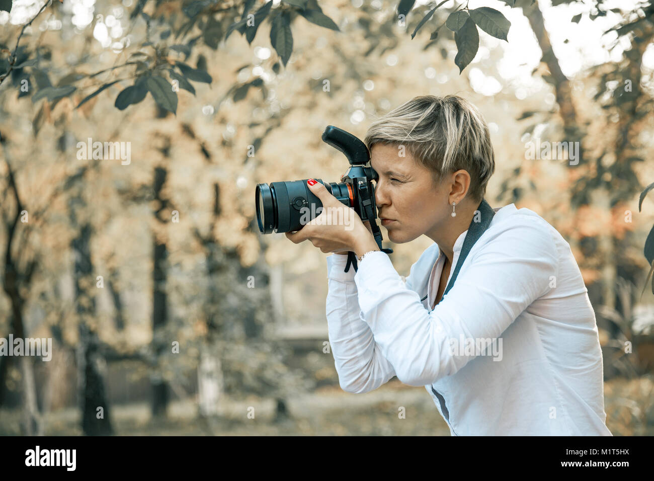 Professional woman photographer taking camera outdoor portraits with ...