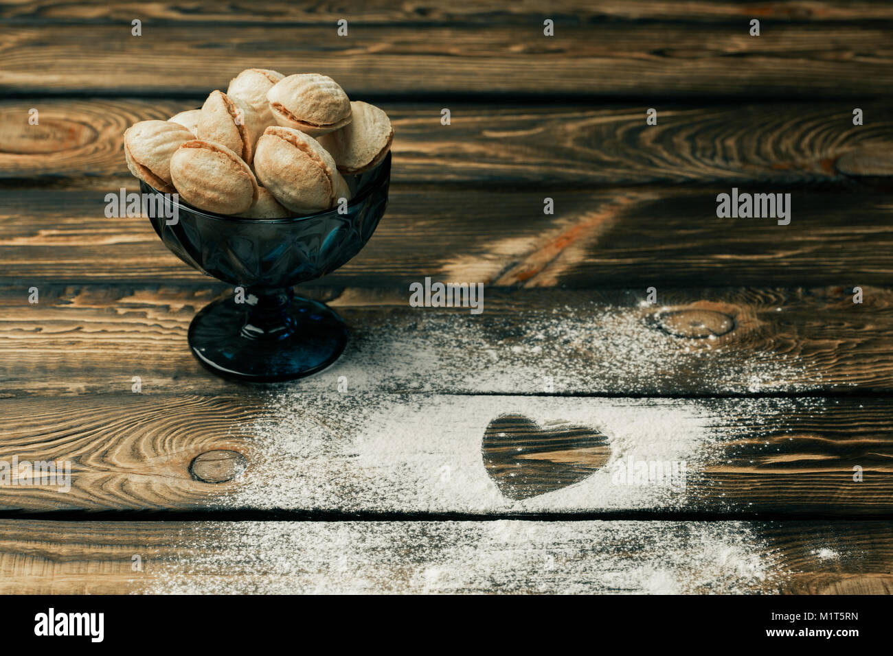 top view of heart shape wheat flour with the letter love. baking nuts ...