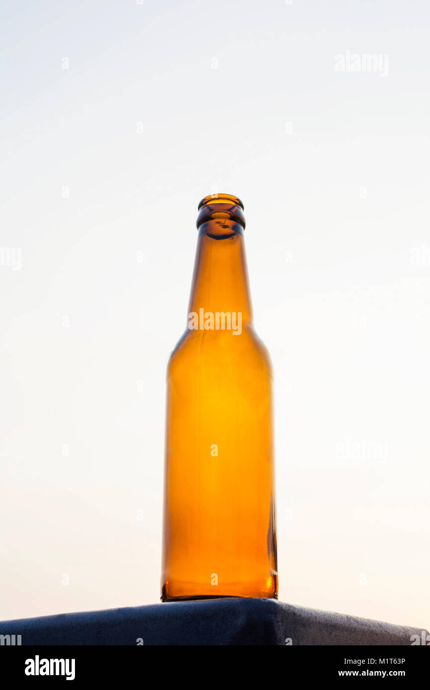 Empty orange beer bottle isolated Stock Photo - Alamy