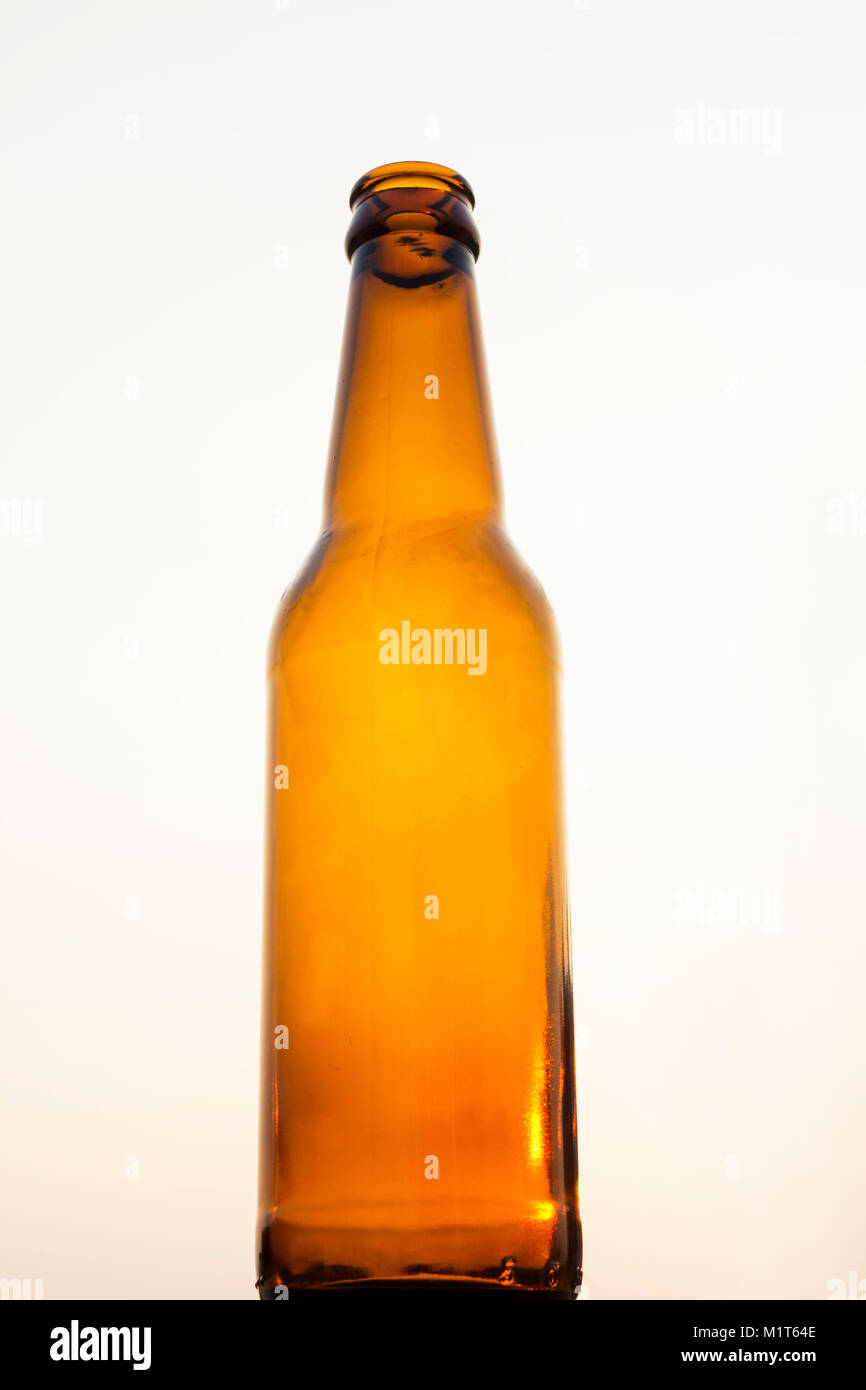 Empty orange beer bottle isolated Stock Photo - Alamy