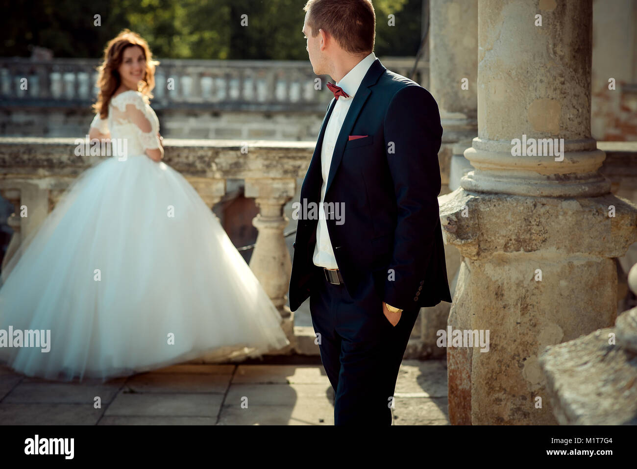 The groom is looking over his shoulder at his charming smiling ginger ...