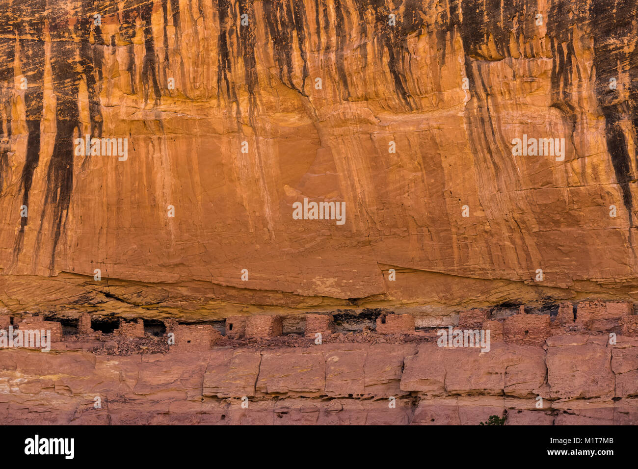 Desert varnish runs down the cliff above Big Ruin, an Ancestral Pueblo ...