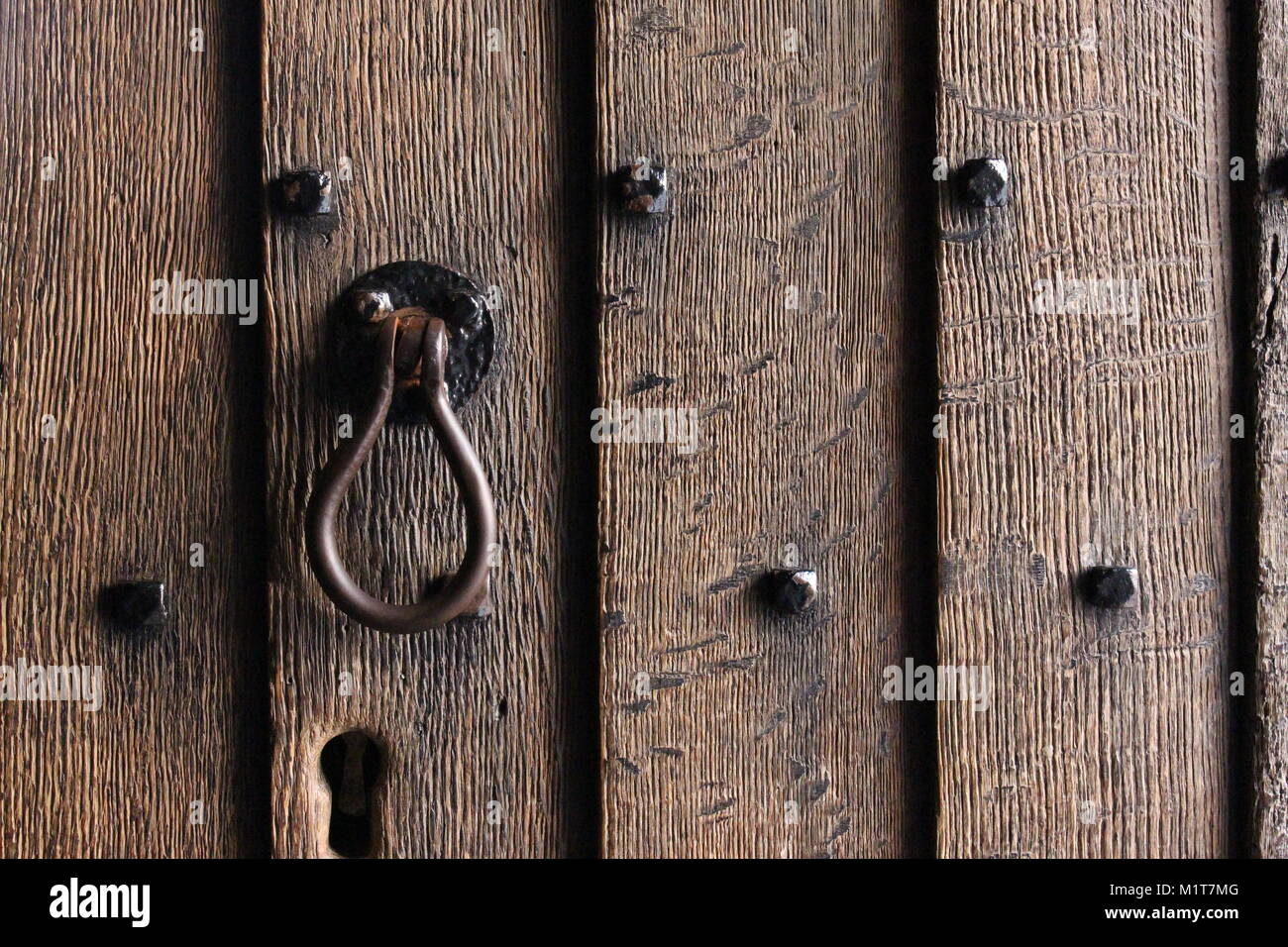 Old door details, with metal studs, and an old door knocker and keyhole ...