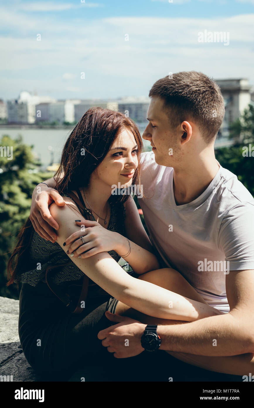 Vertical portrait of the beautiful loving couple tenderly hugging while ...