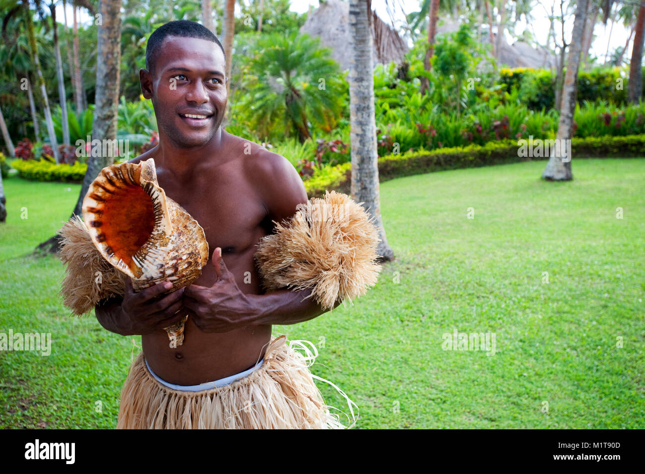 A performer prepares to sound a conch shell at Jean-Michel Cousteau’s ...