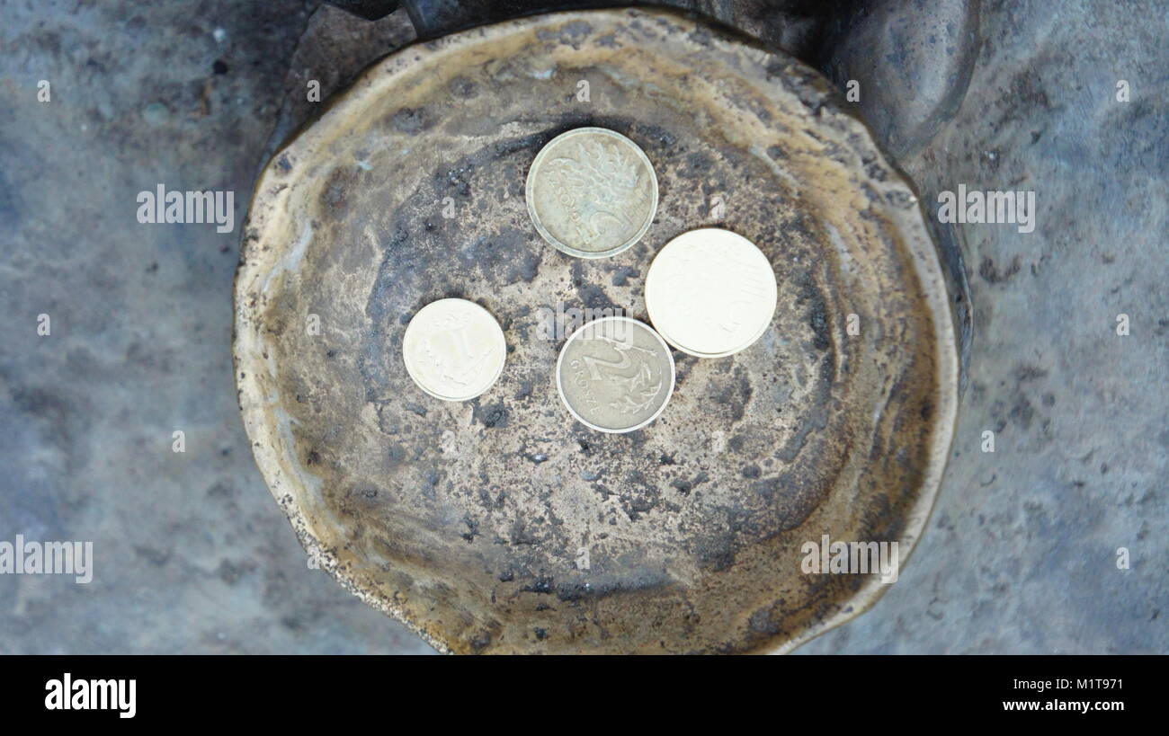 coins of money for homeless man Stock Photo - Alamy