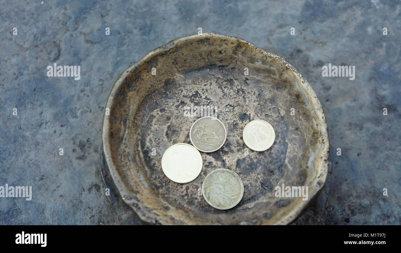 coins of money for homeless man Stock Photo - Alamy