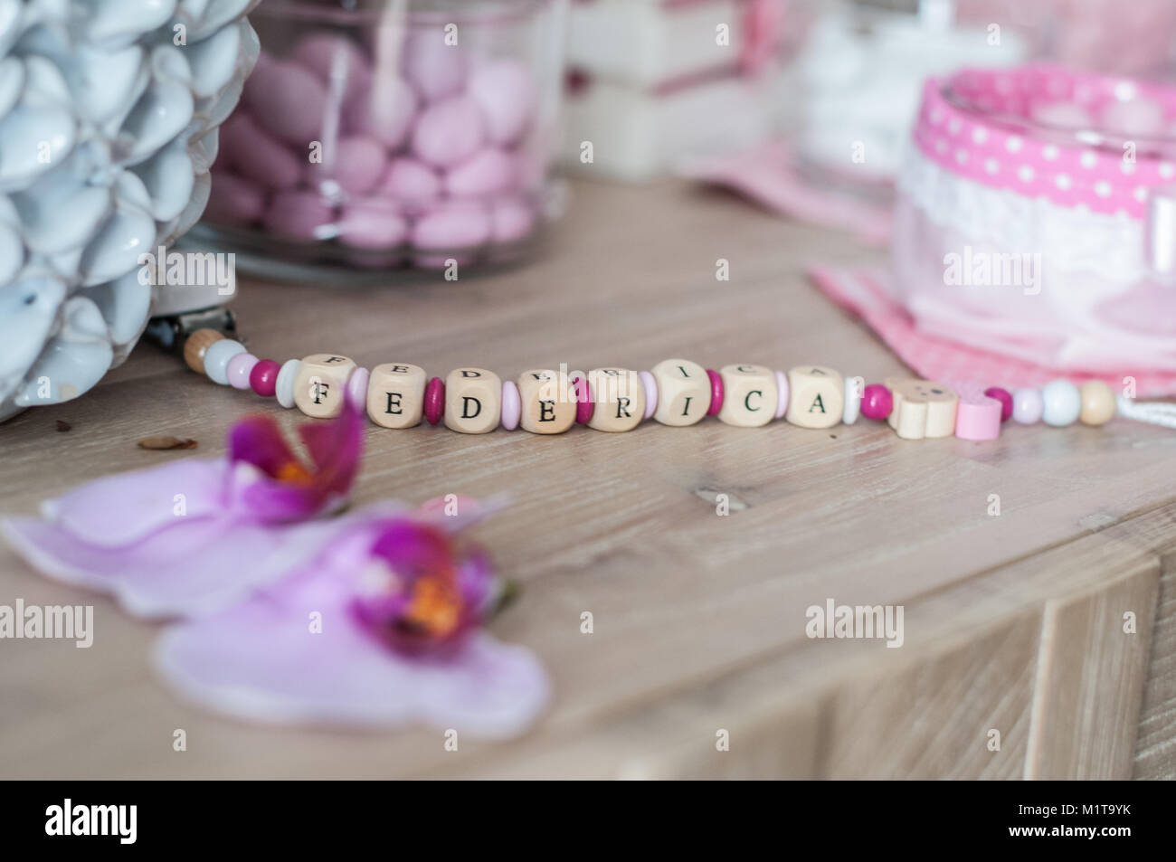 newborn girl table set with glass containers with different pink ...