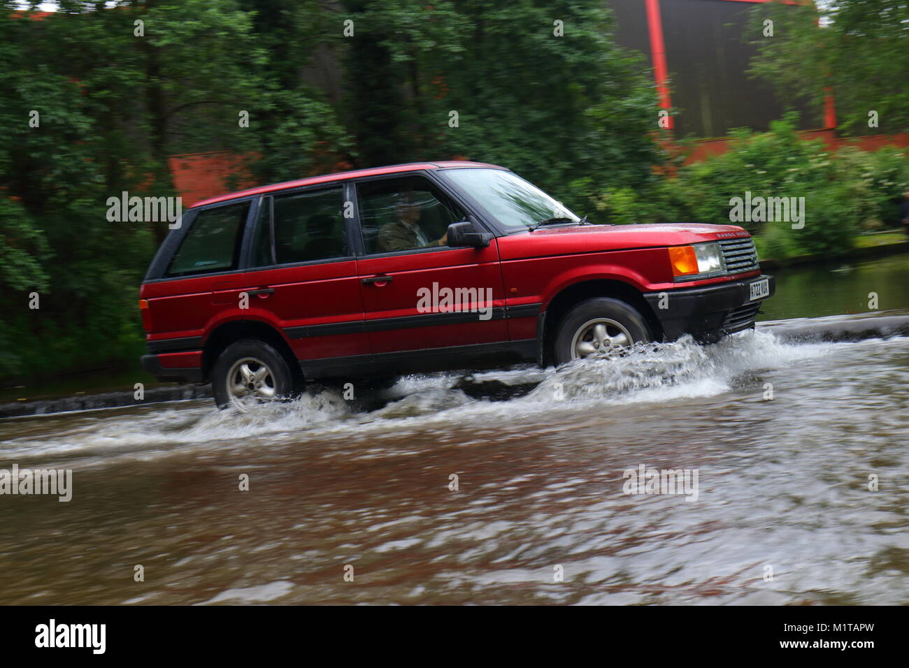 A Range Rover drives through a river ford in Ripon during an annual ...
