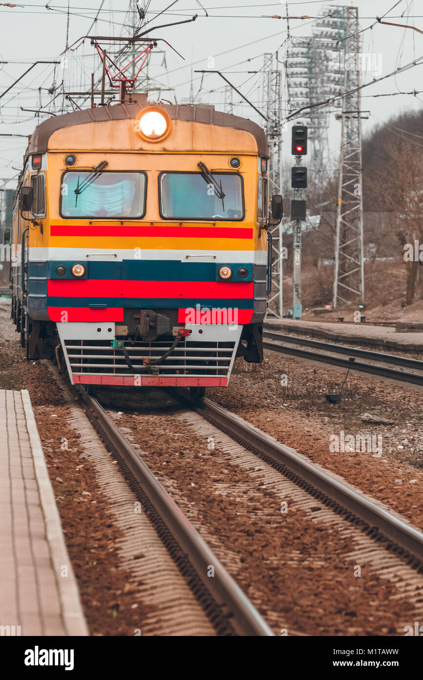 Old yellow passenger electric train driving at the terminal Stock Photo ...