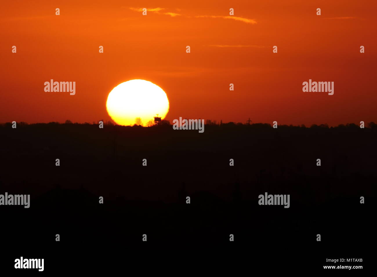 UK Sun rising above the horizon in Leeds with Pontefract Water Tower in ...