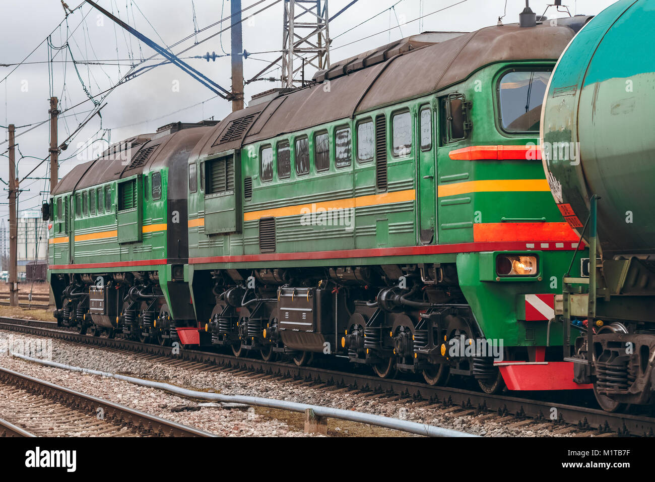 Green diesel cargo locomotive. Freight train in action Stock Photo - Alamy