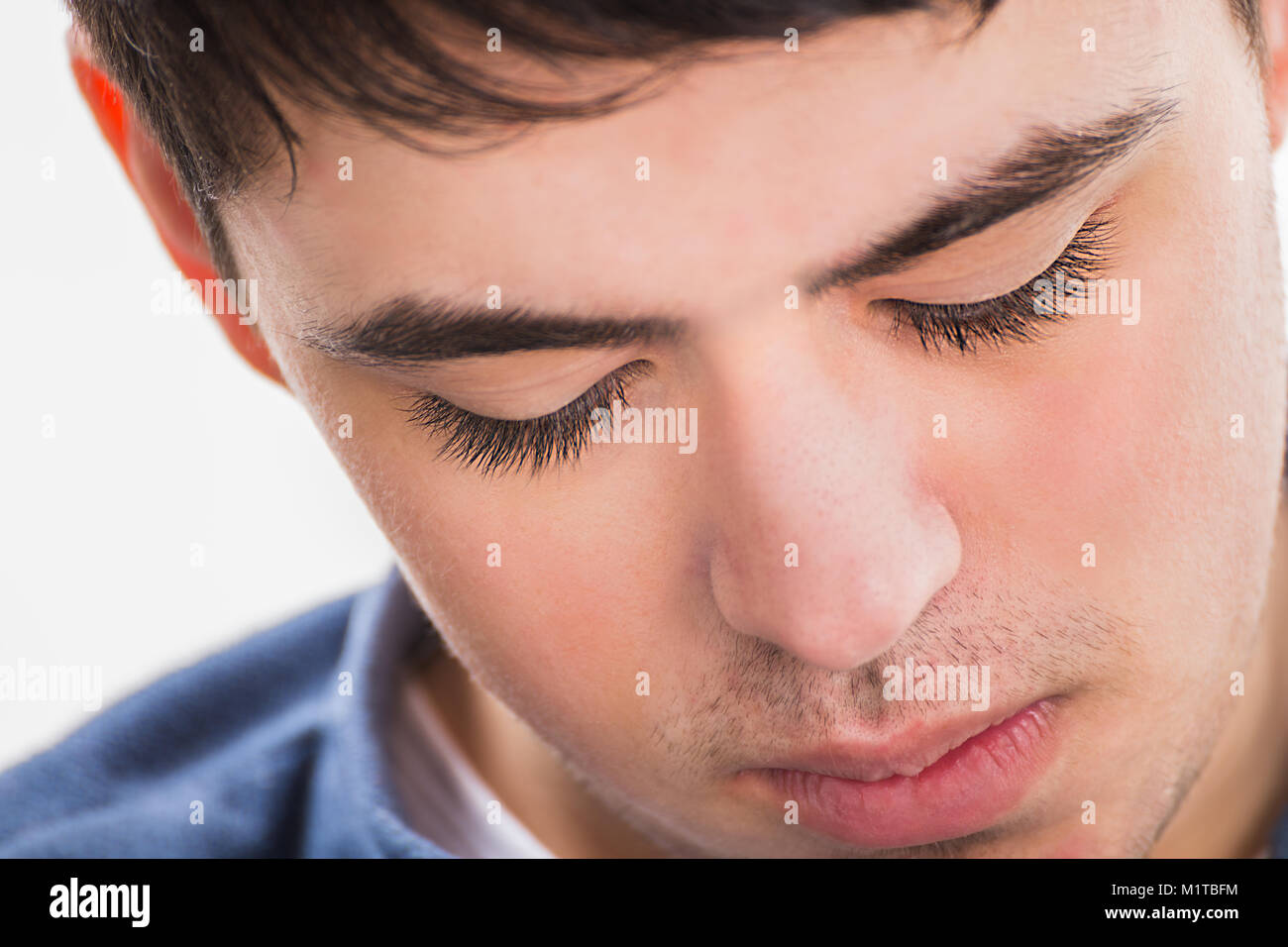extreme closeup of black eyelashes of teenage boy looking down Stock ...