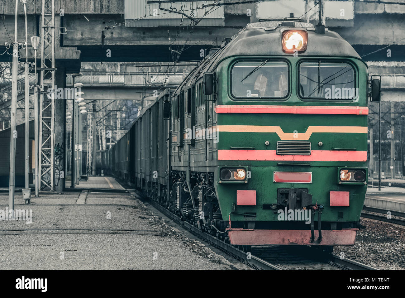 Green diesel cargo locomotive. Freight train in action Stock Photo - Alamy