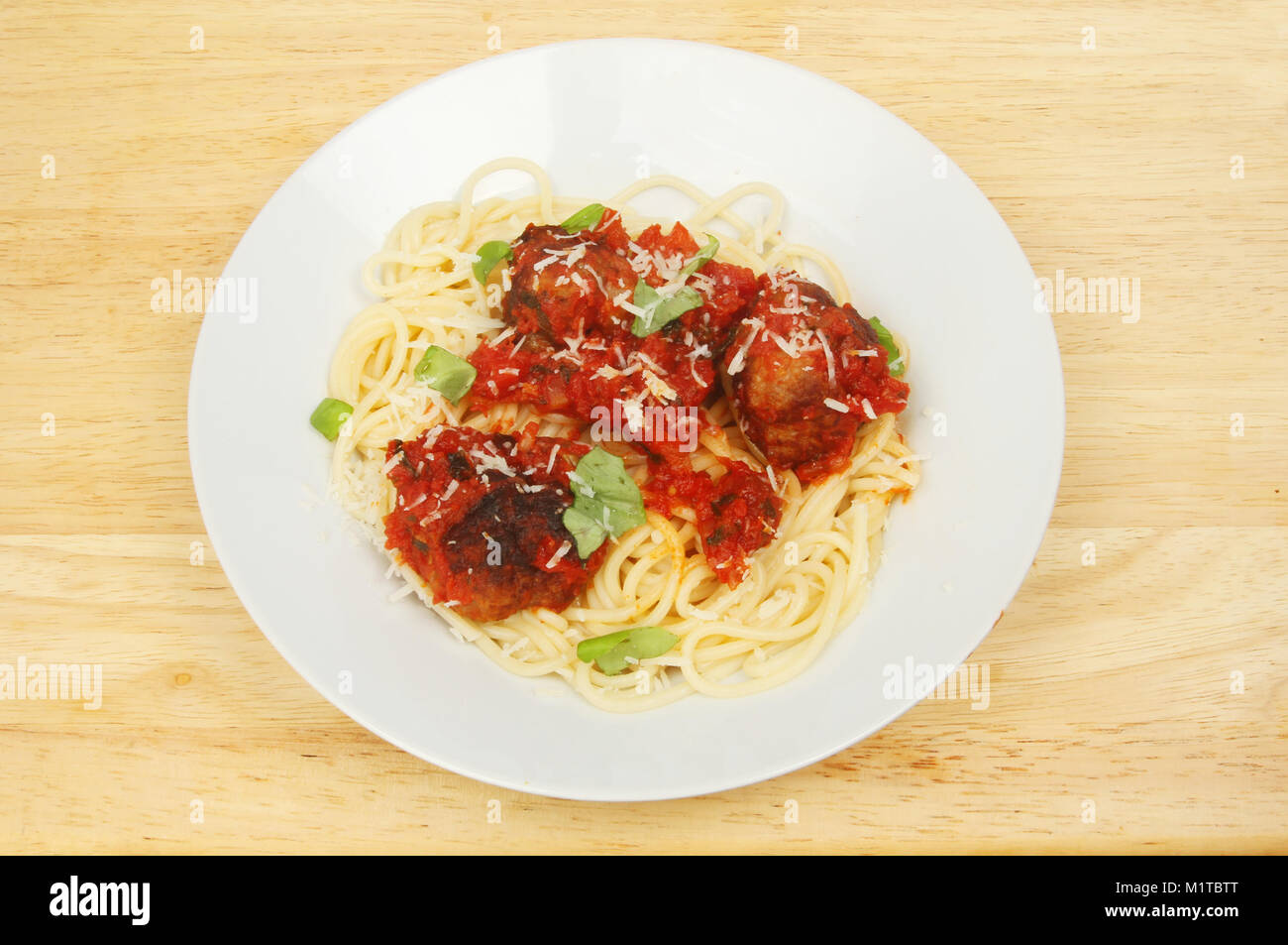 Spaghetti and meatballs in a bowl on a wooden tabletop Stock Photo - Alamy