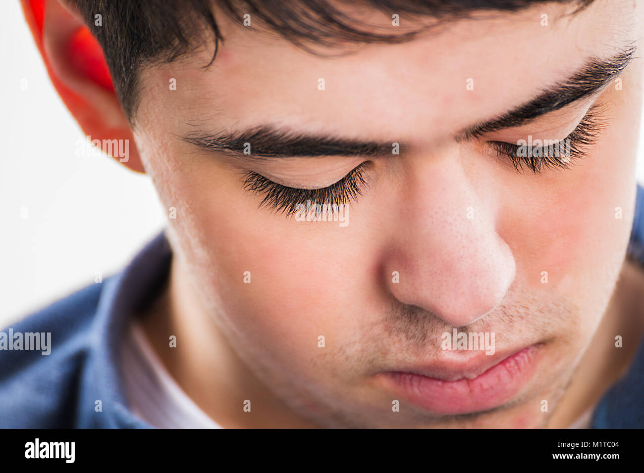 extreme closeup of black eyelashes of teenage boy looking down Stock ...