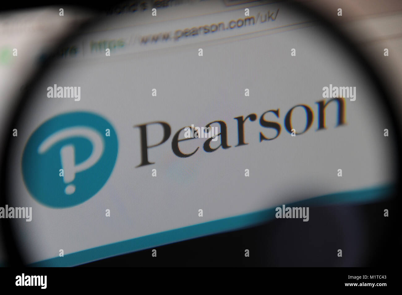 The Pearson website seen through a magnifying glass Stock Photo - Alamy